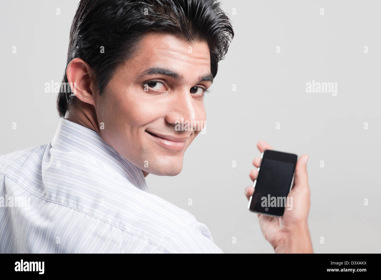 Portrait of a man holding a mobile phone Stock Photo - Alamy