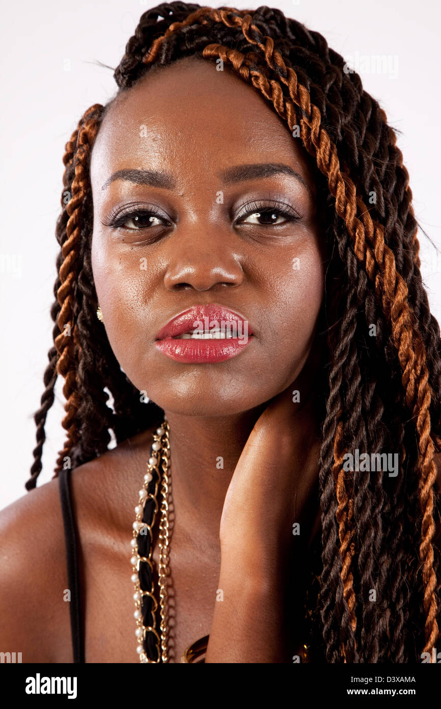 Pretty black woman with long dread locks, looking at the camera with a ...