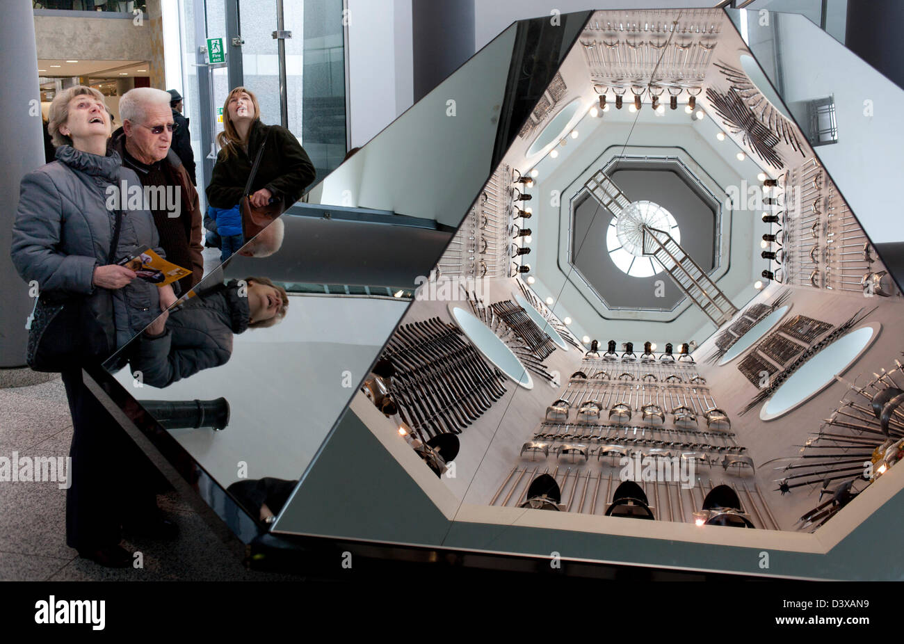 People looking up into the "Hall of Steel" which exhibits weapons of ...