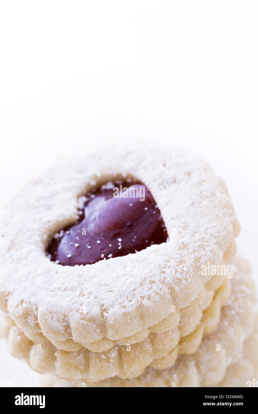 Linzer Torte cookies on white background with powdered sugar sprinkled ...