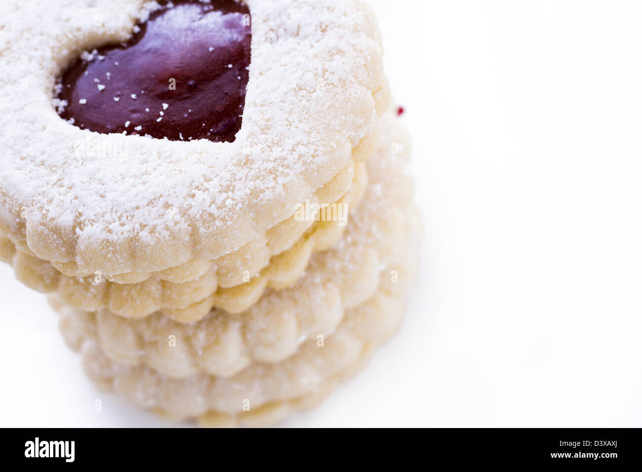 Linzer Torte cookies on white background with powdered sugar sprinkled ...