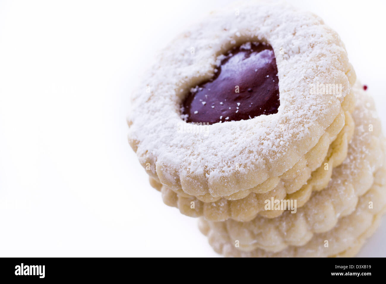 Linzer Torte cookies on white background with powdered sugar sprinkled ...