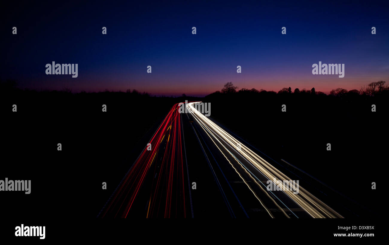 Light trails into a beautiful sunset Stock Photo - Alamy