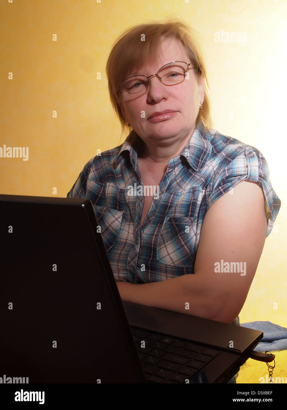 Middle age woman on her laptop computer Stock Photo - Alamy