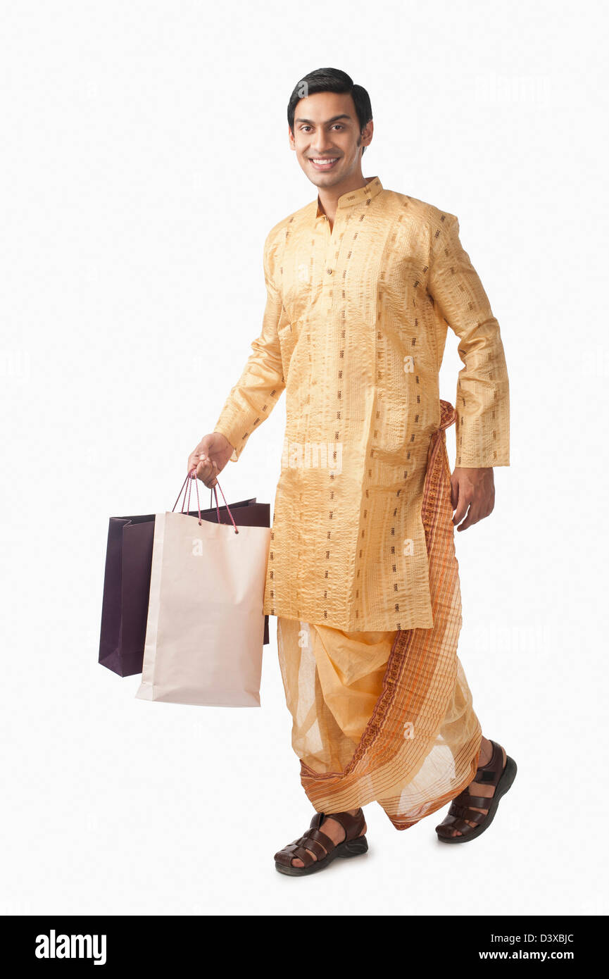 Bengali man carrying shopping bags and smiling Stock Photo - Alamy