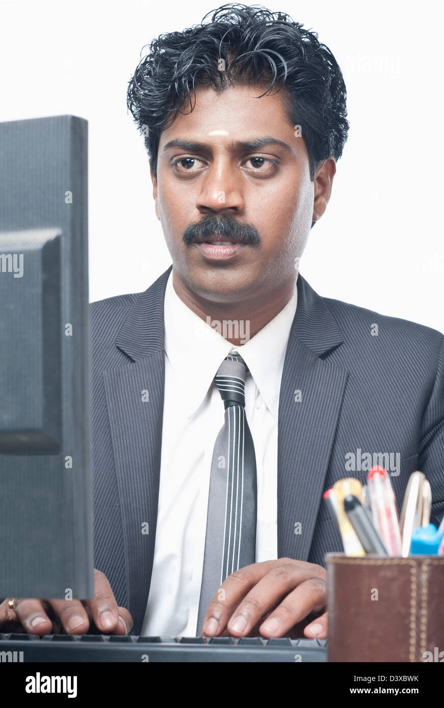 South Indian businessman working on a computer Stock Photo - Alamy