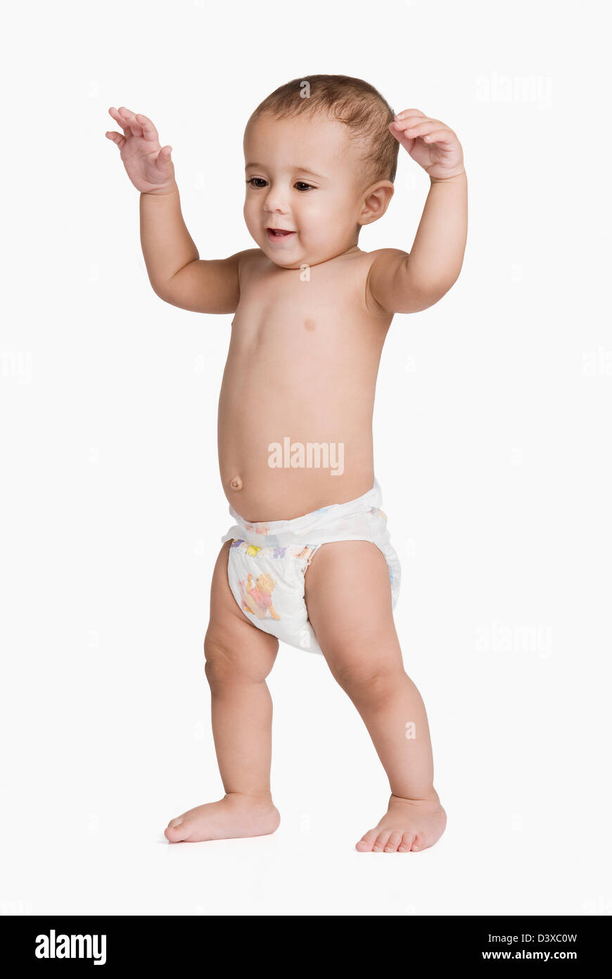 Baby boy standing and smiling Stock Photo - Alamy