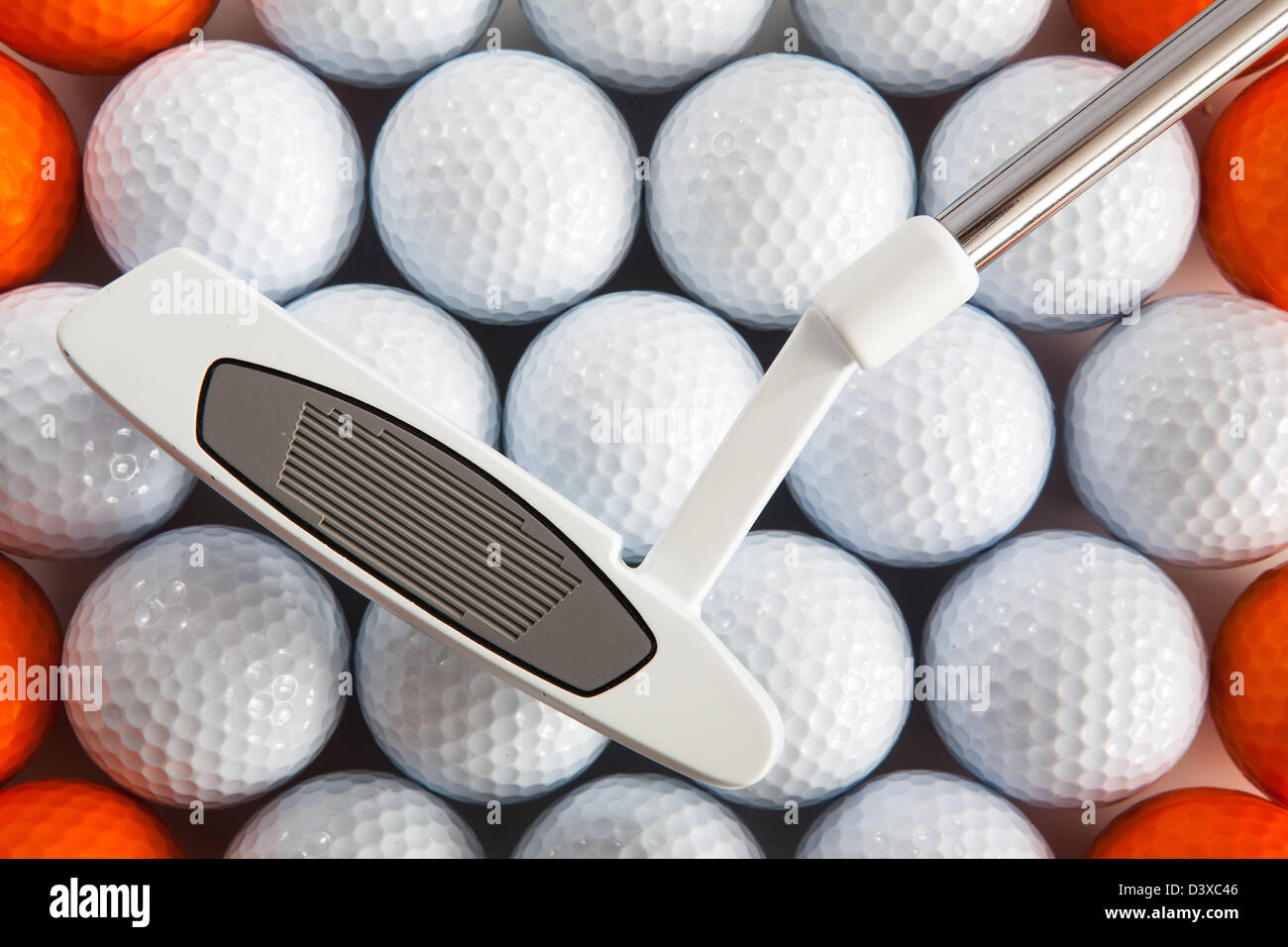 Golf putter and different golf balls Stock Photo - Alamy