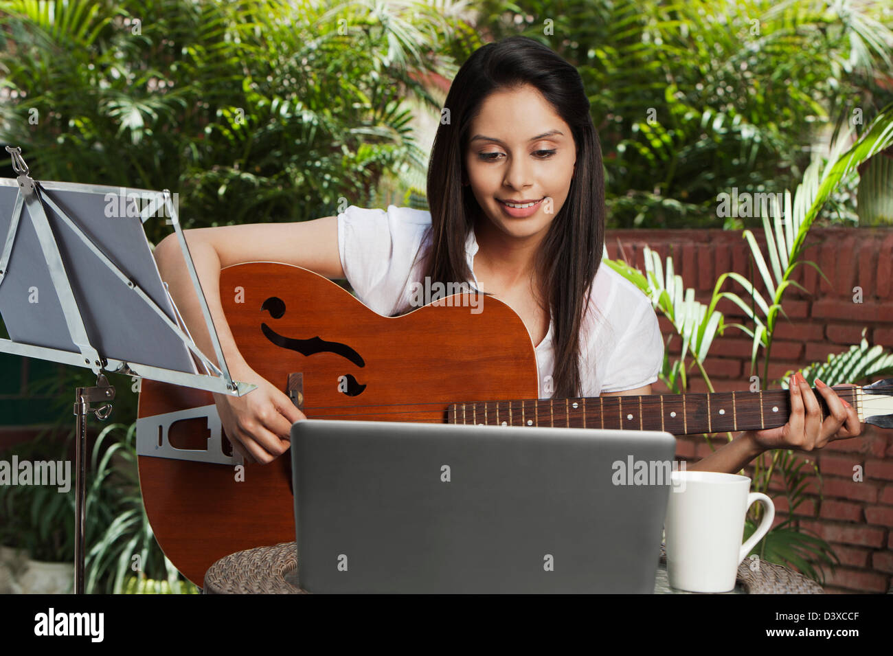 Woman playing a guitar Stock Photo - Alamy