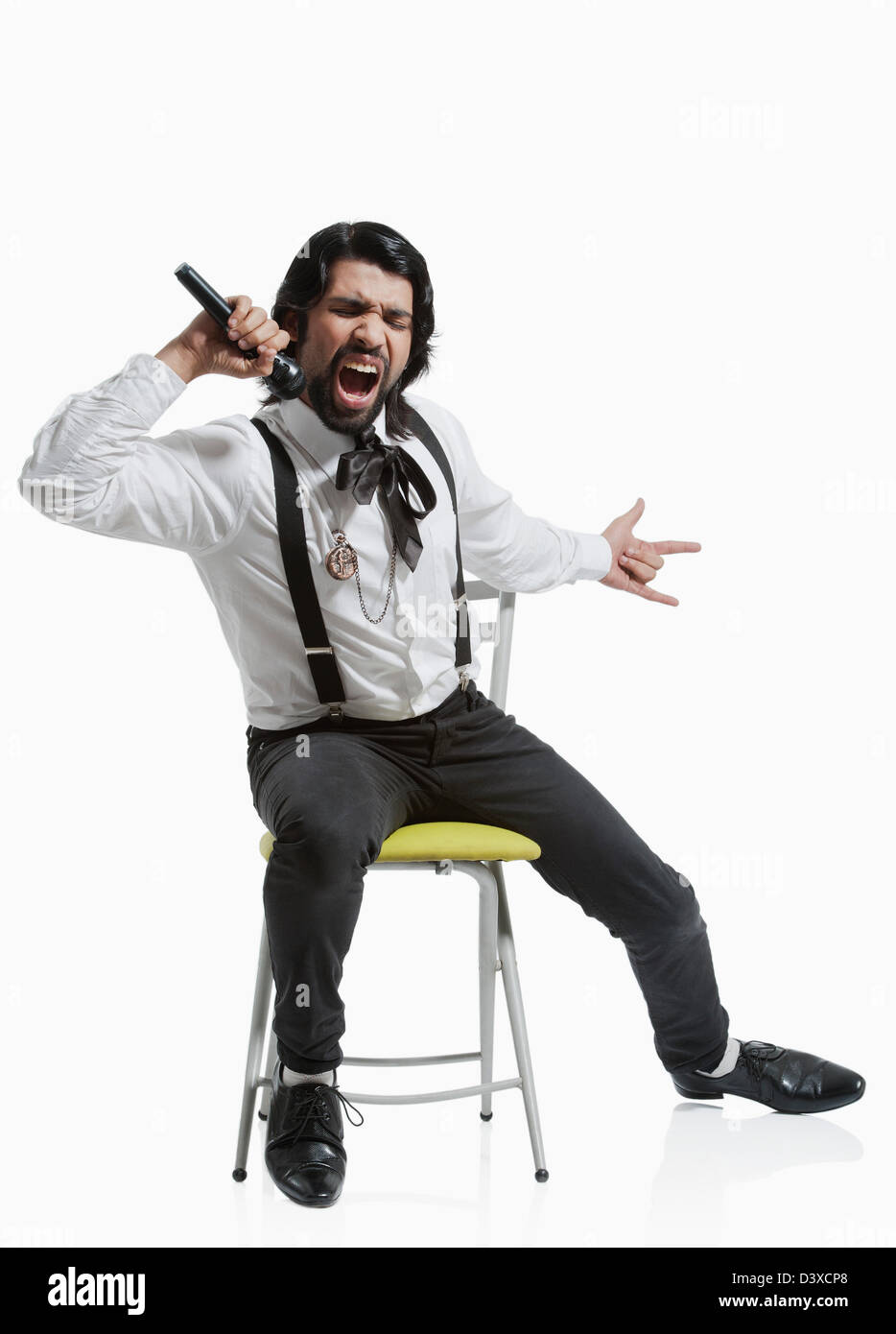 Singer holding a mike and singing Stock Photo - Alamy