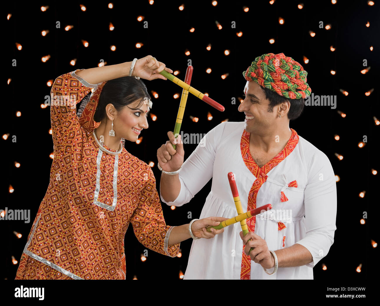 Couple performing Dandiya Raas at Navratri Stock Photo - Alamy