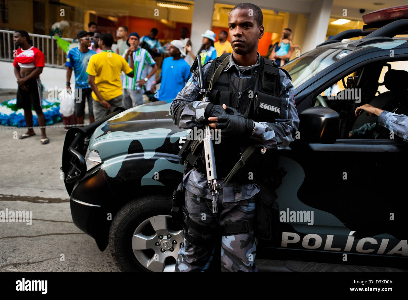 A Brazilian policeman guards the street during the Carnival parade in ...