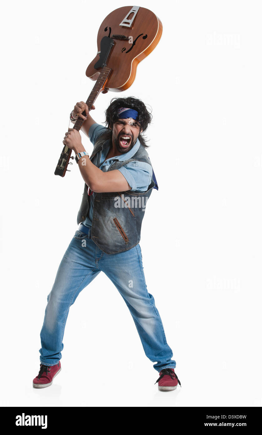 Musician breaking a guitar Stock Photo - Alamy