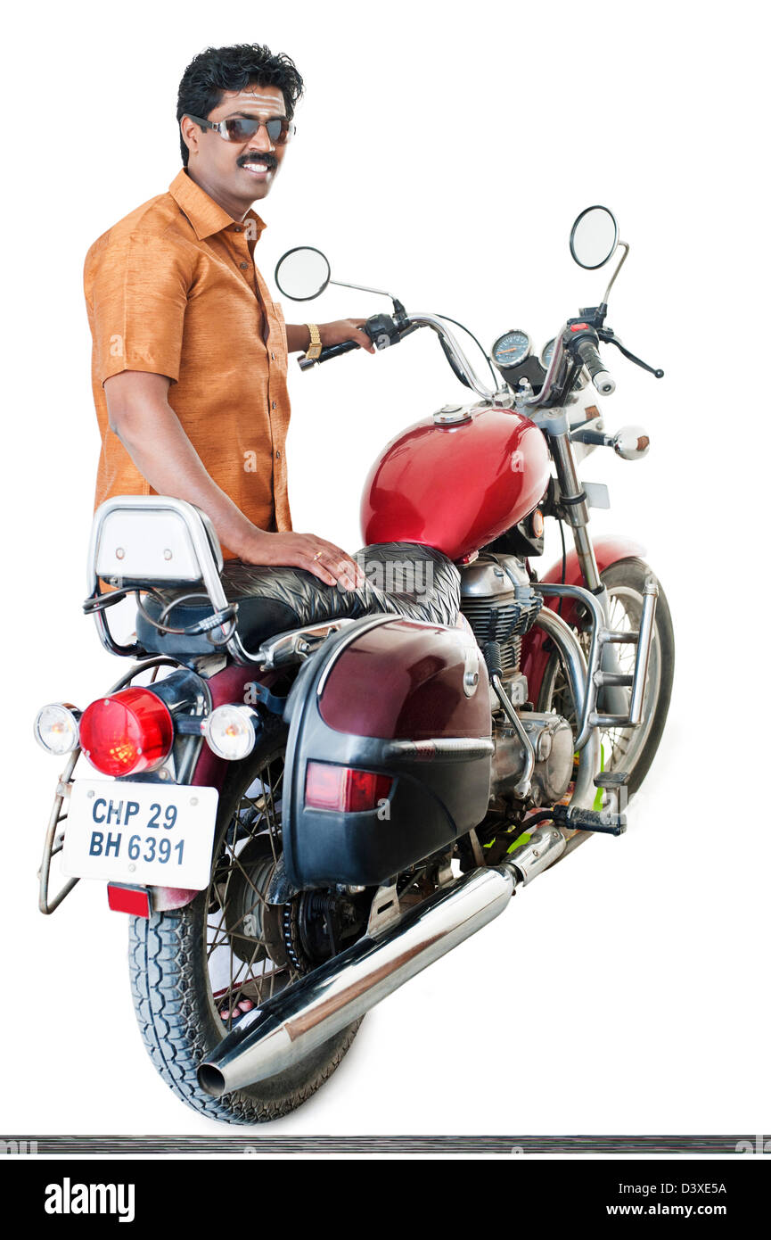 South Indian man standing near a motorcycle Stock Photo - Alamy