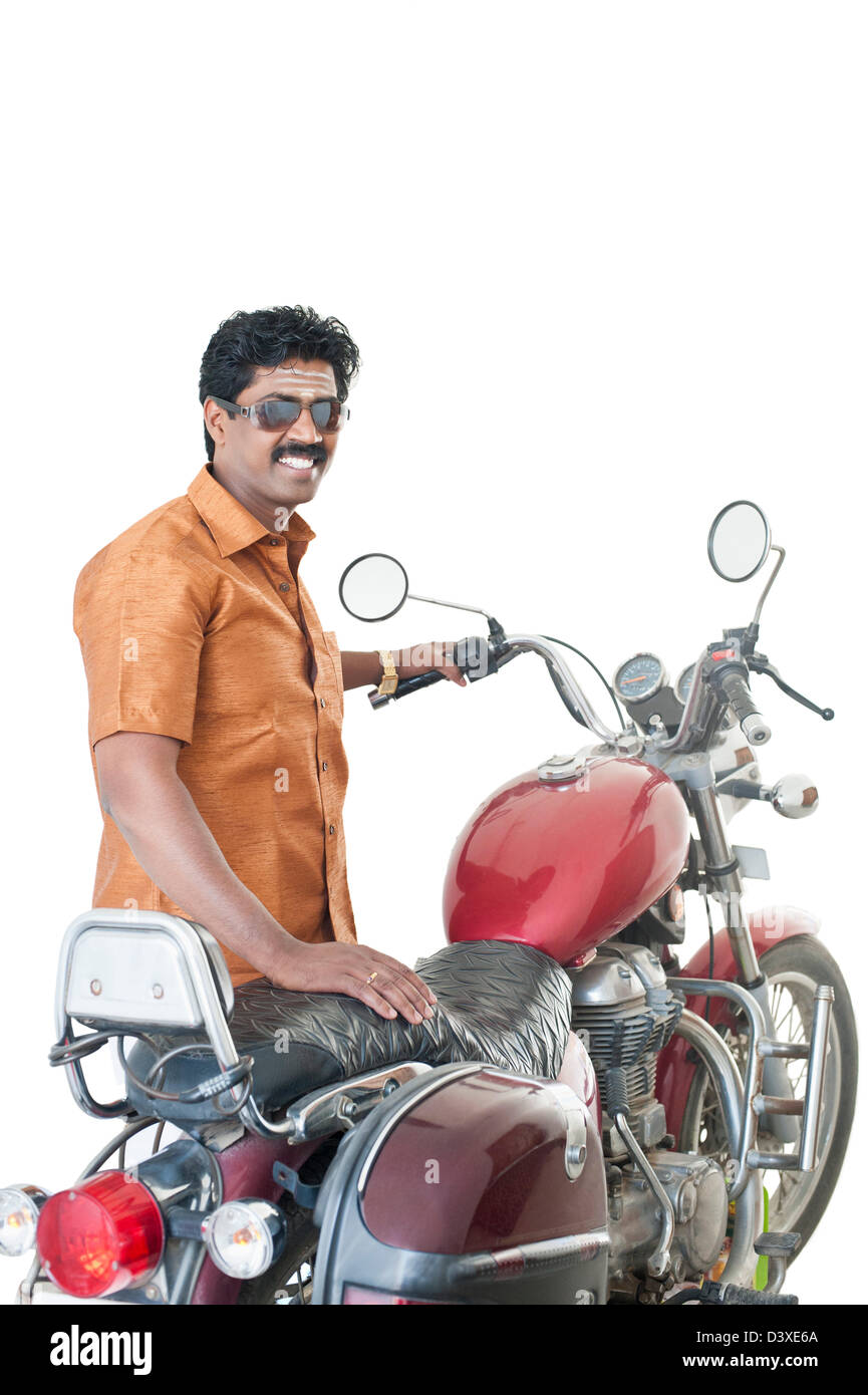 South Indian man standing near a motorcycle Stock Photo - Alamy