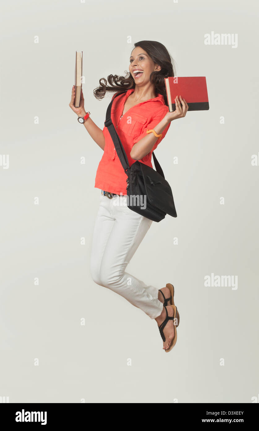 Jumping with books hi-res stock photography and images - Alamy