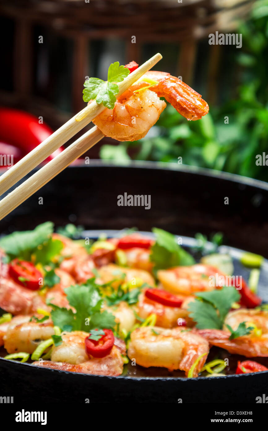 Closeup of fried shrimp on chopsticks Stock Photo - Alamy