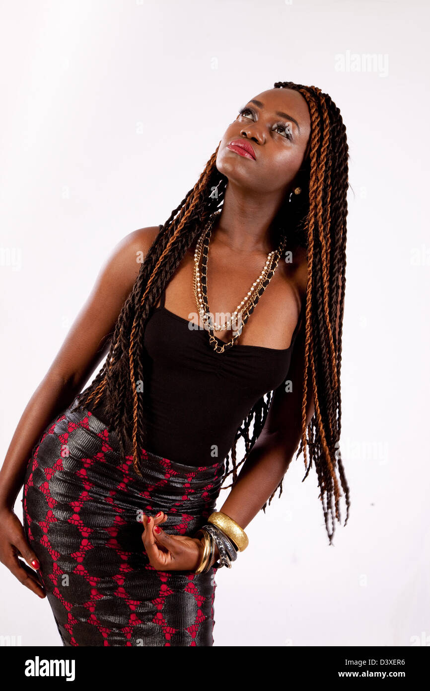Pretty back woman in long dread locks, reaching to her waist, looking ...