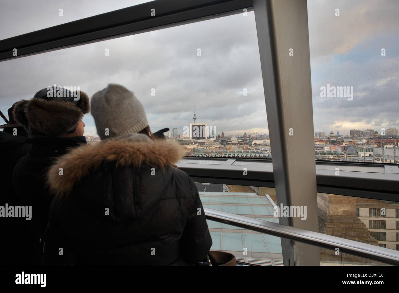 Berlin, Germany, visitors to the Reichstag dome at the window and look ...