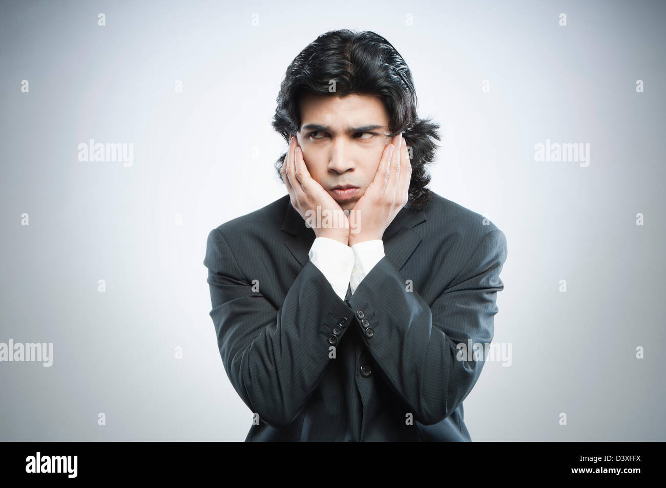 Businessman looking displeased Stock Photo - Alamy