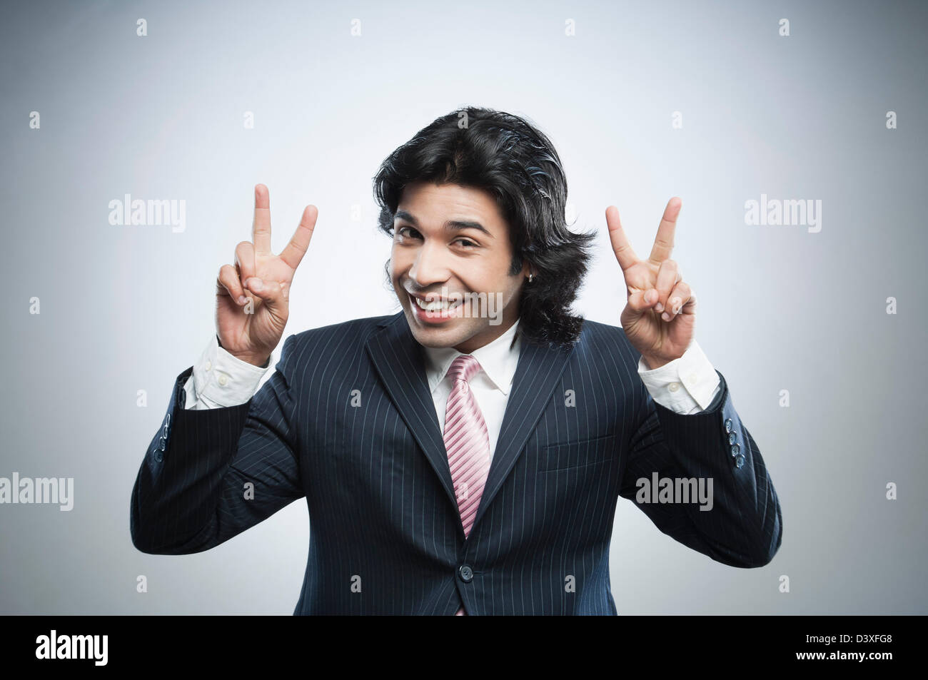 Businessman showing victory sign with his both hands Stock Photo - Alamy