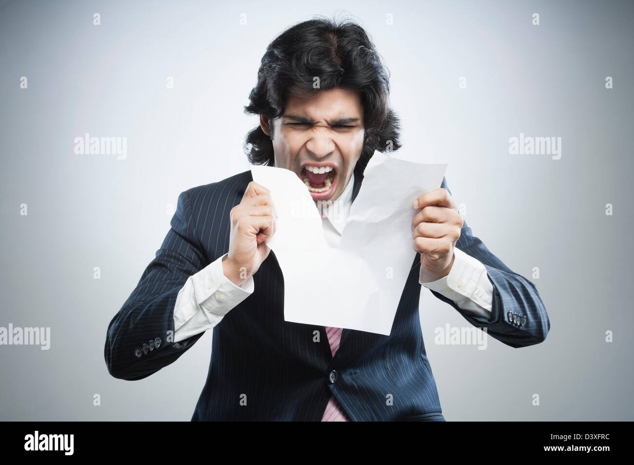Angry businessman tearing paper hi-res stock photography and images - Alamy