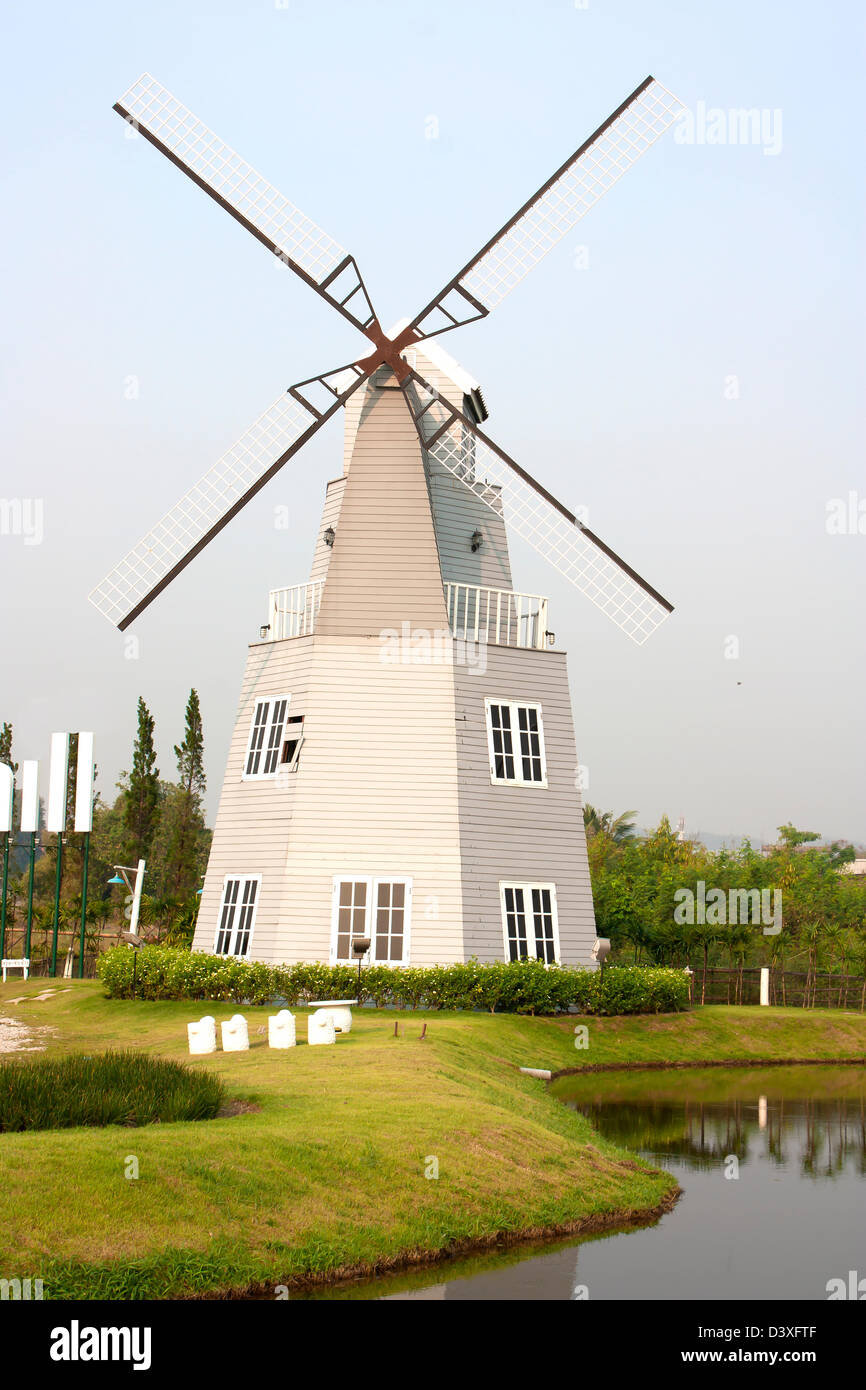 House with wind turbine sky background green grass Stock Photo - Alamy