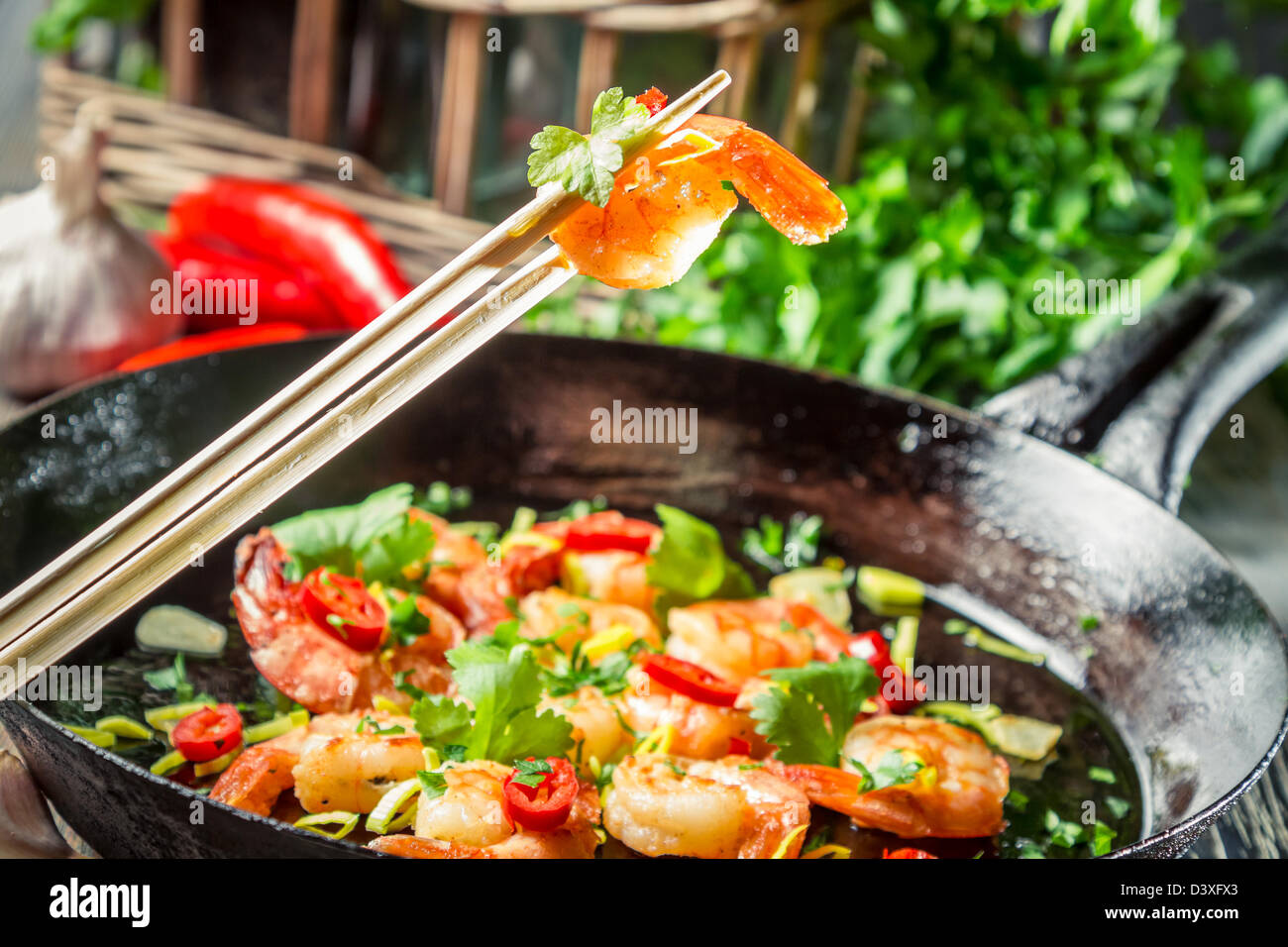 Fried shrimp on chopsticks with herbs Stock Photo - Alamy