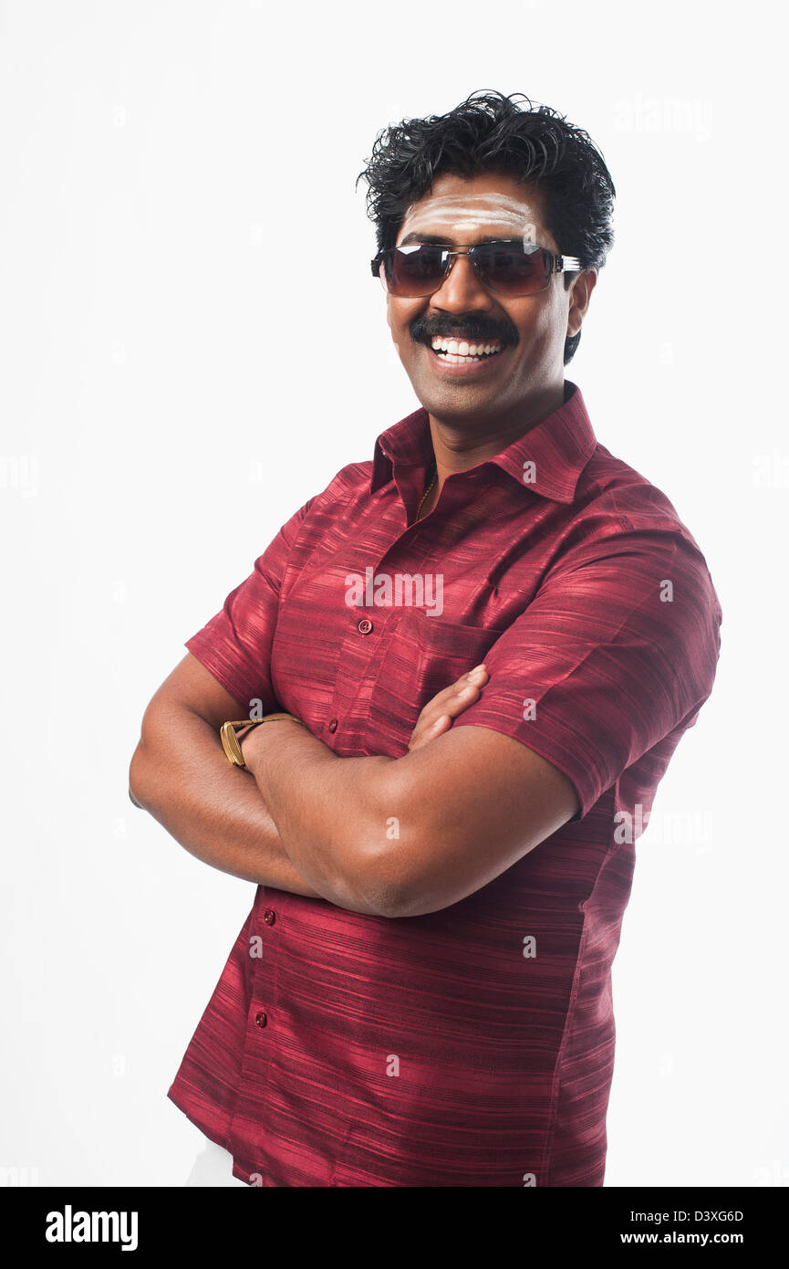 South Indian man standing with his arms crossed and smiling Stock Photo ...