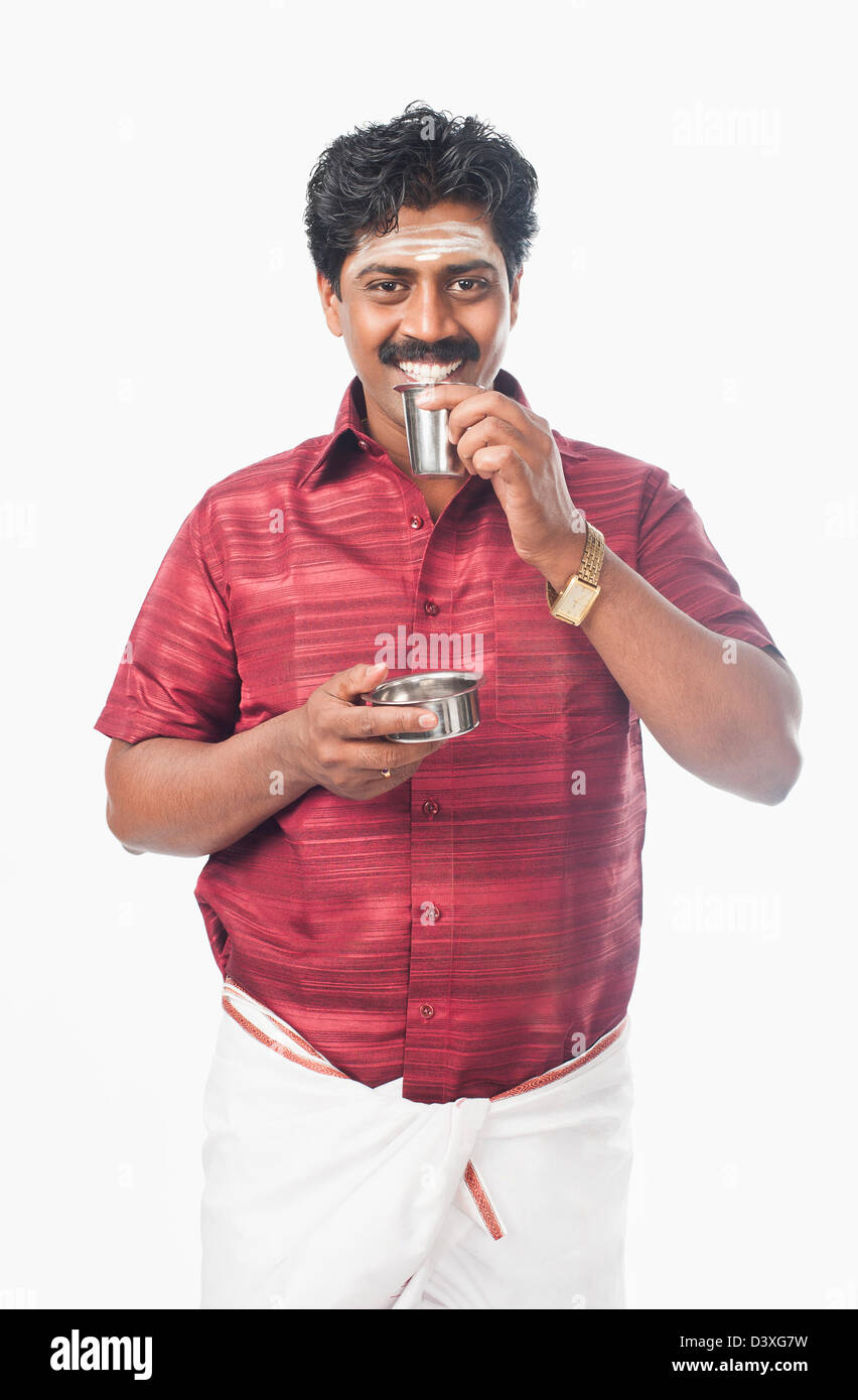 South Indian man having tea Stock Photo - Alamy