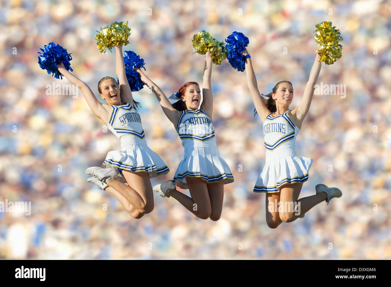 Caucasian cheerleaders jumping in mid-air Stock Photo - Alamy