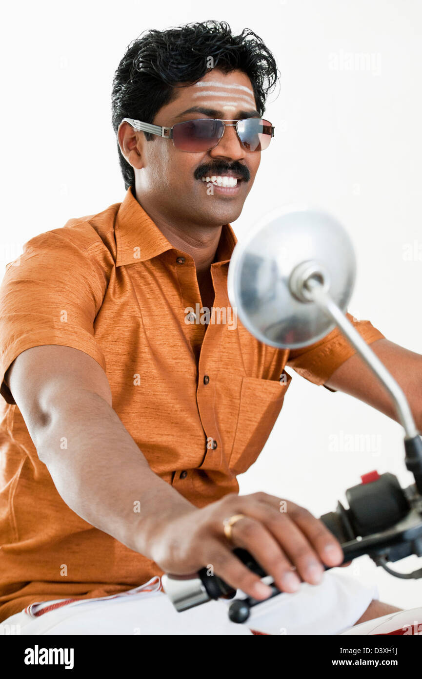 South Indian man riding a motorcycle Stock Photo - Alamy