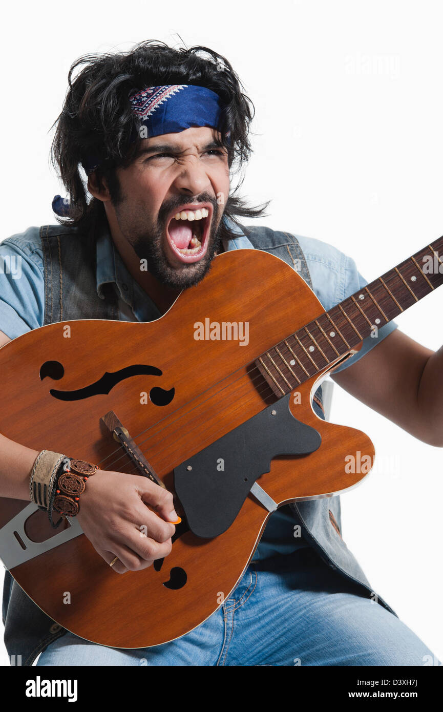 Musician playing a guitar Stock Photo - Alamy