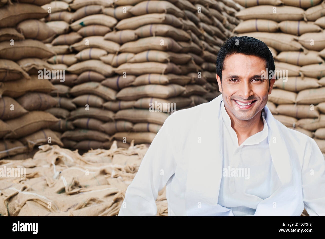 Man smiling near sacks of wheat grains, Anaj Mandi, Sohna, Gurgaon ...