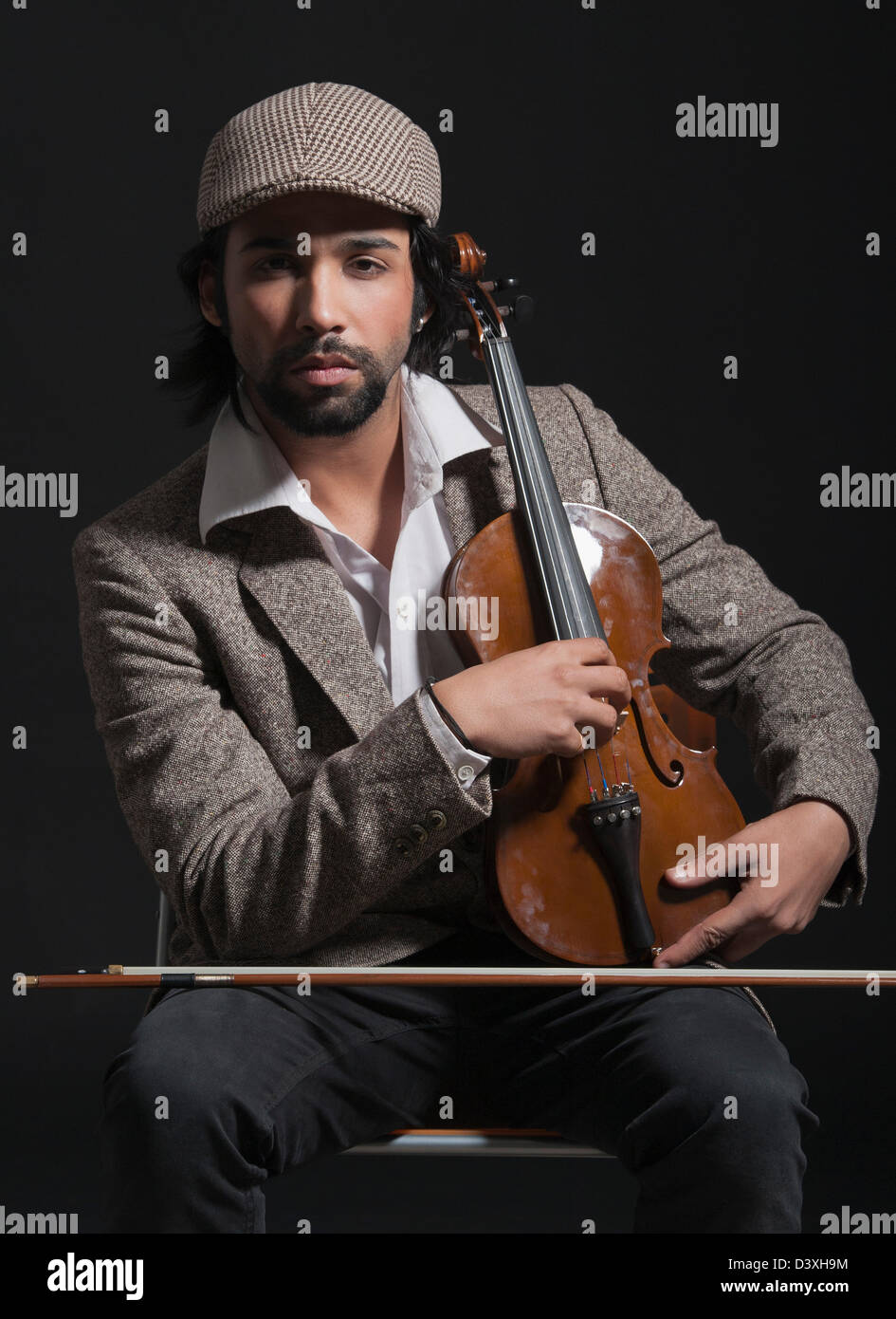 Young musician is holding a violin and bow hi-res stock photography and ...