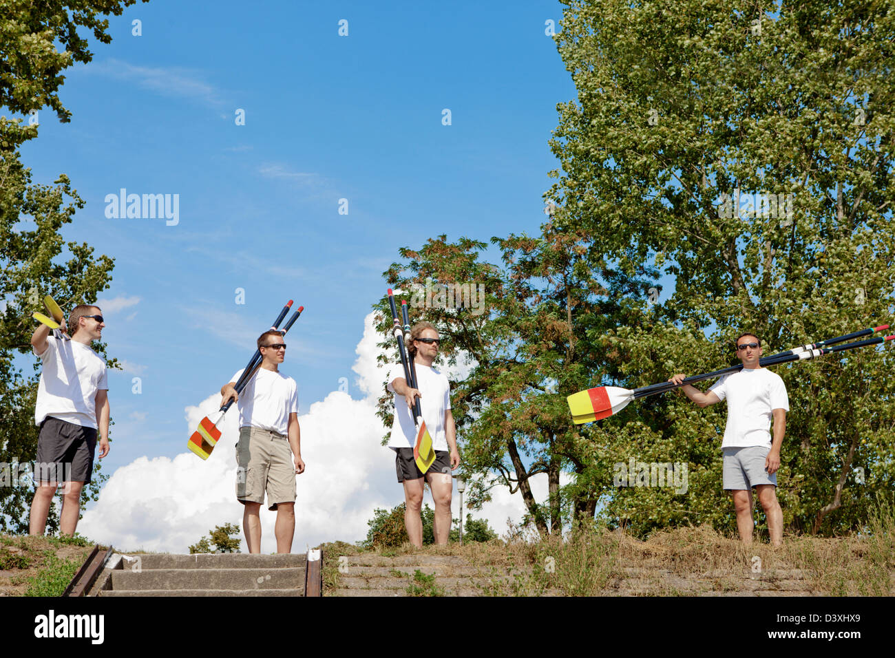 Teamwork Concept of Men Rowing Team Carrying Paddles on Shoulder Stock ...