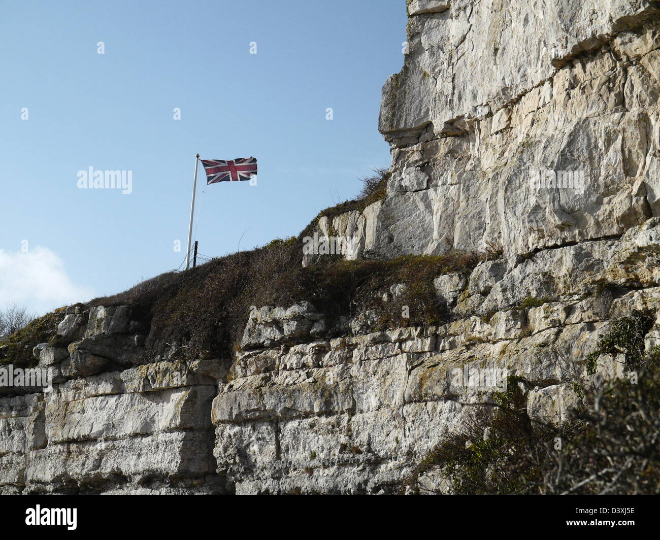 Rock face of Portland stone - union Jack flag flying above Stock Photo ...