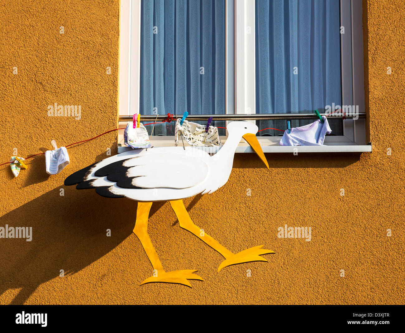Stork and clothes hanging on a house. Customs will, from neighbors ...