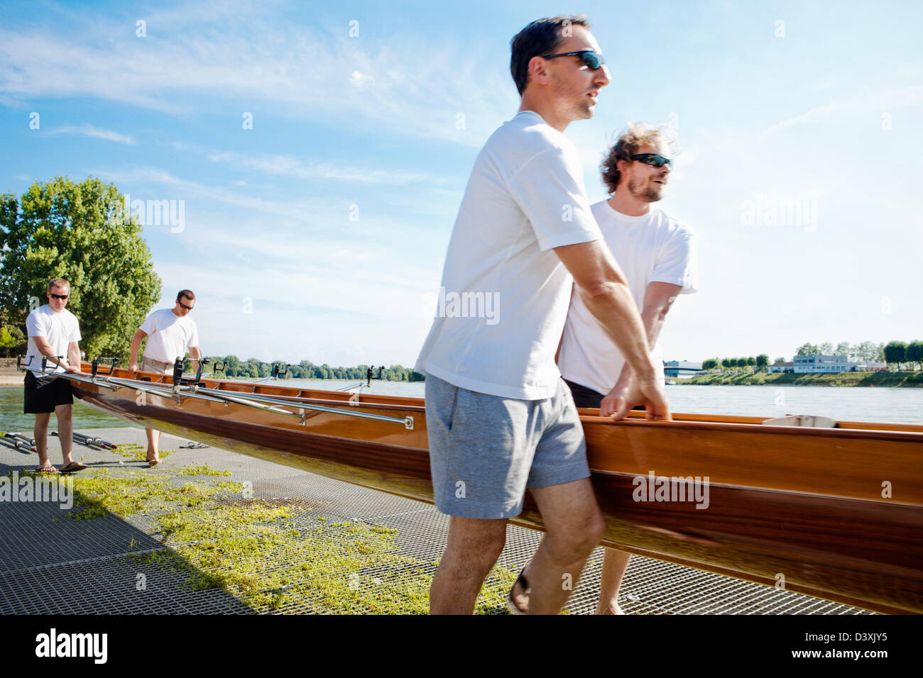 Teamwork Concept of Men Rowing Team Carrying Boat to Water Stock Photo ...
