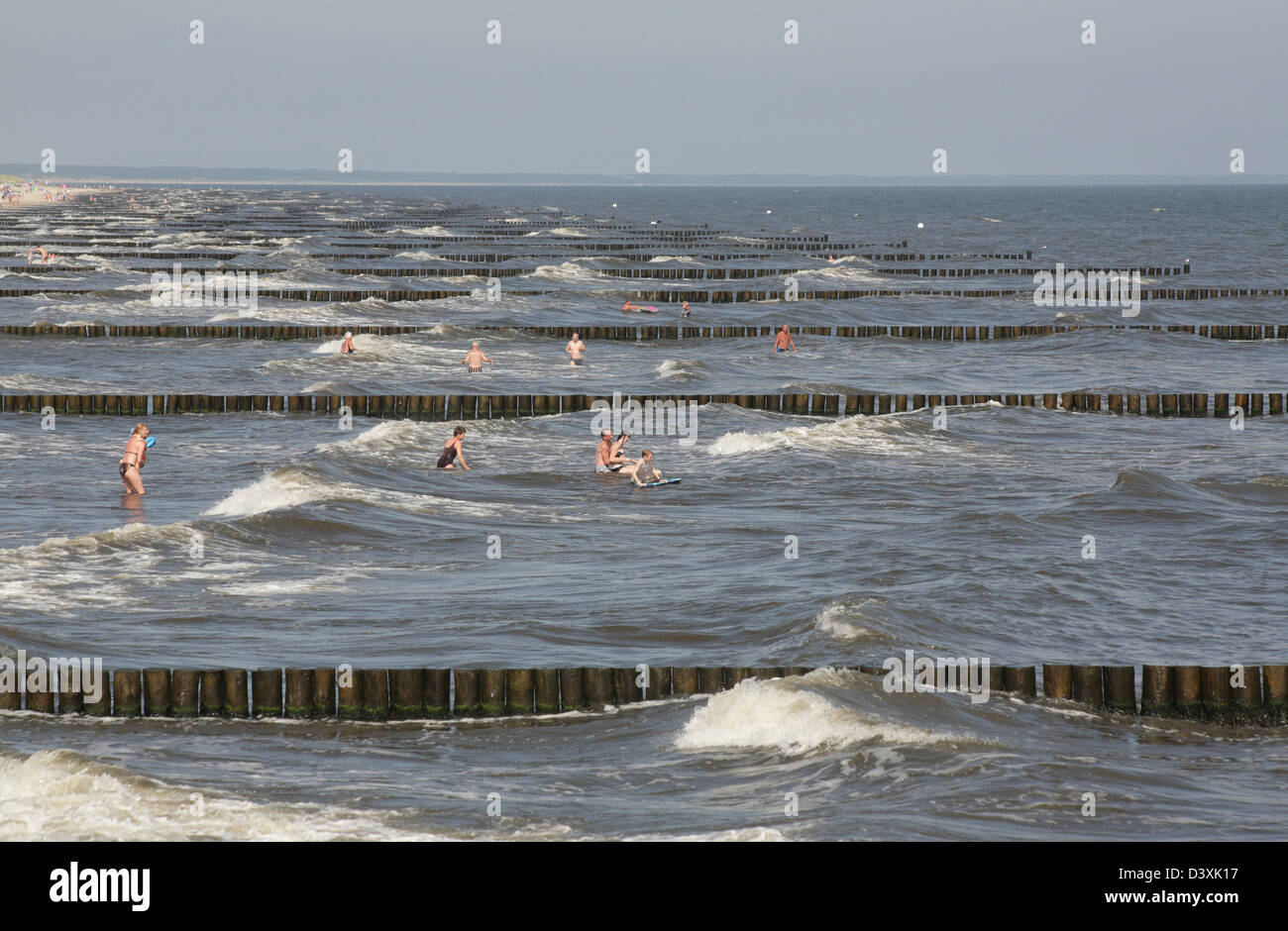 Koserow, Germany, in the Baltic timber groynes with beach tourists ...