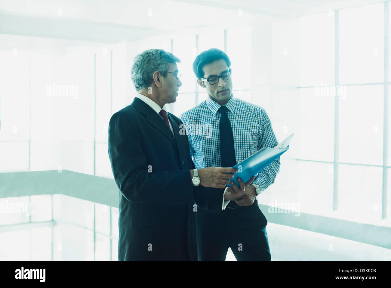 Business men discussing a document Stock Photo - Alamy