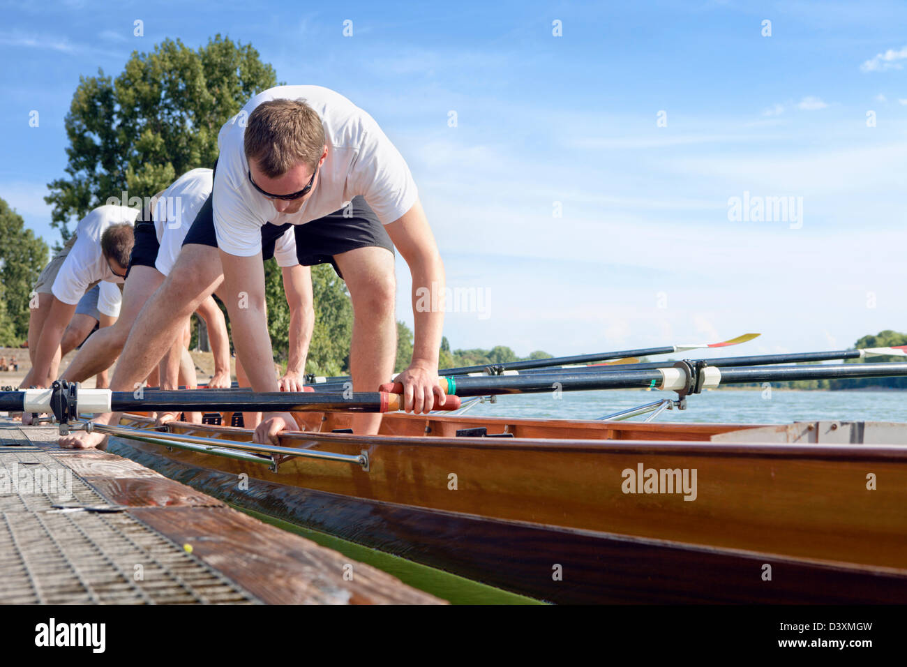 Teamwork Concept of Men Rowing Team Mounting Boat Stock Photo - Alamy