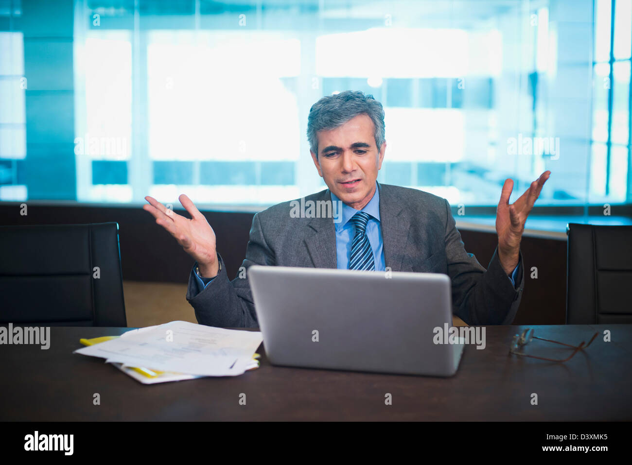Businessman angry with laptop Stock Photo - Alamy