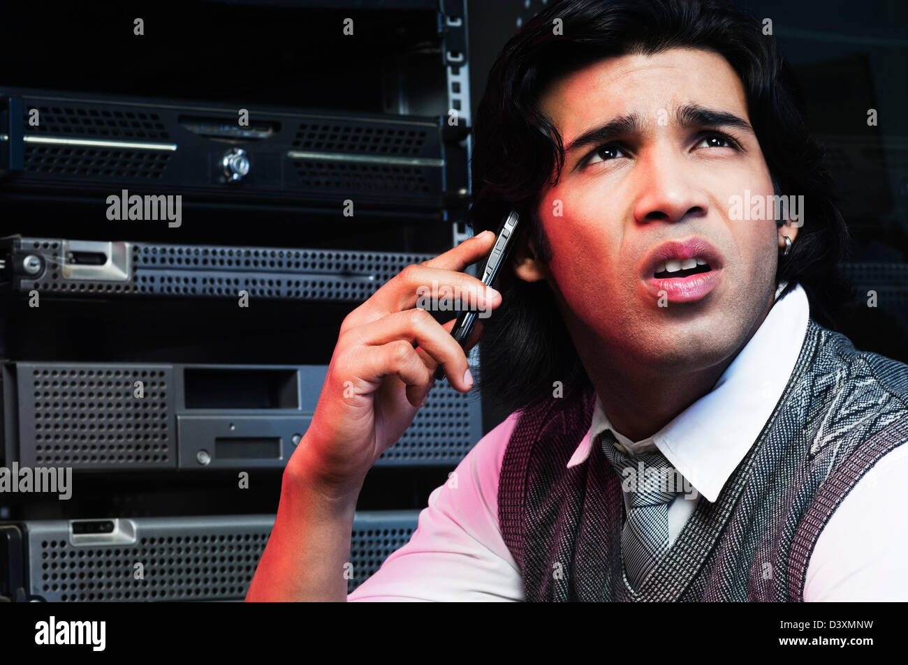 Networking engineer talking on a mobile phone in a server room Stock ...