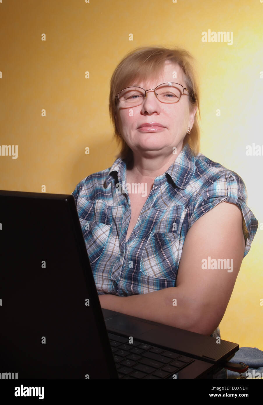 Middle age woman on her laptop computer Stock Photo - Alamy