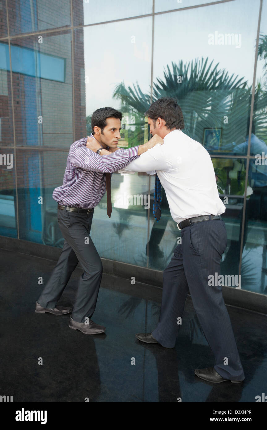 Two businessmen fighting to each other Stock Photo - Alamy