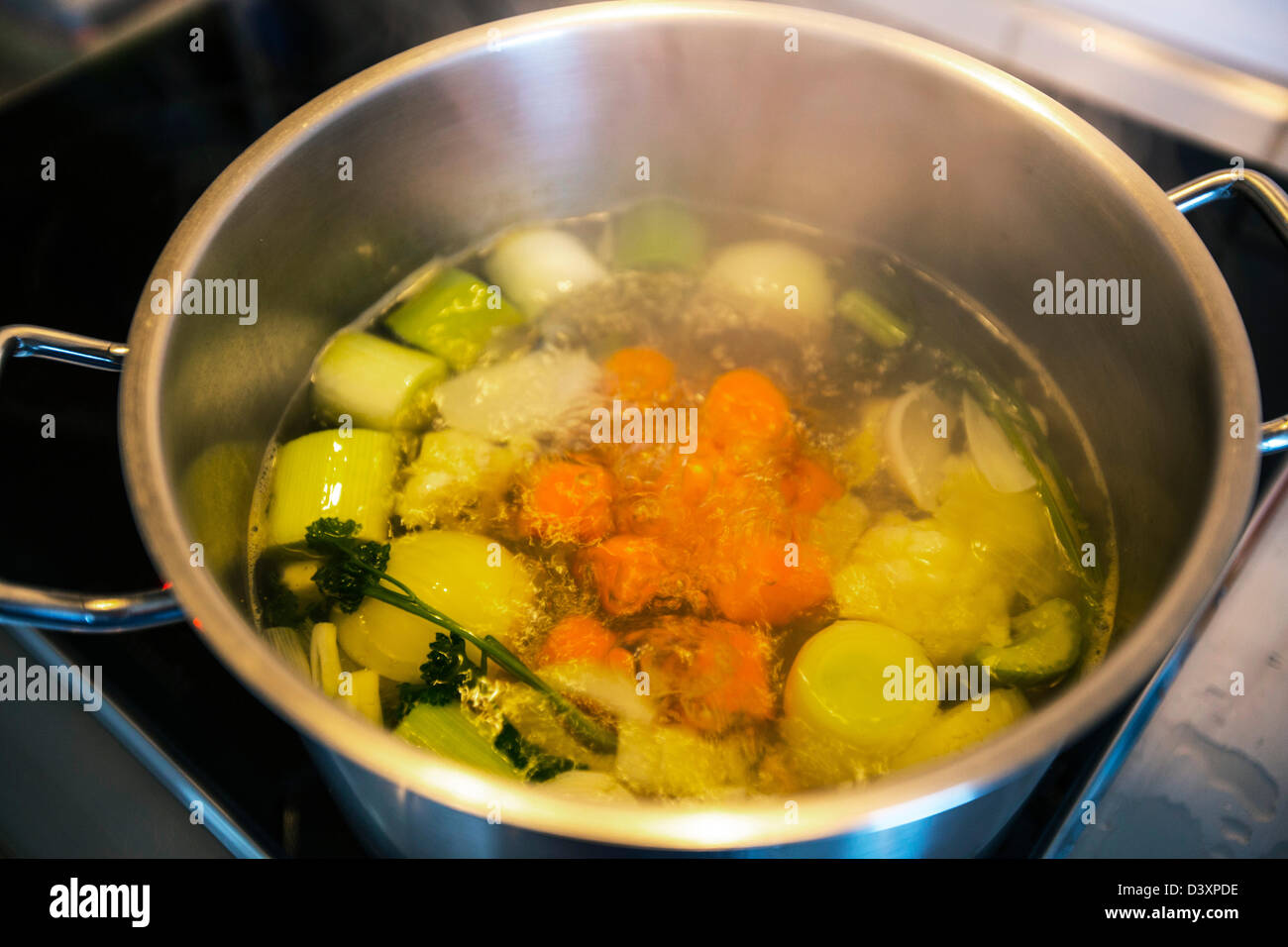 Different vegetables cooking in a pot for a vegetable soup Stock Photo ...