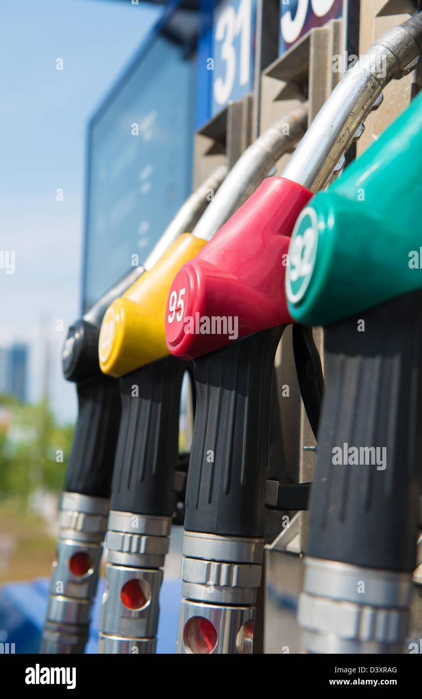 Four gas pump nozzles by closeup Stock Photo - Alamy