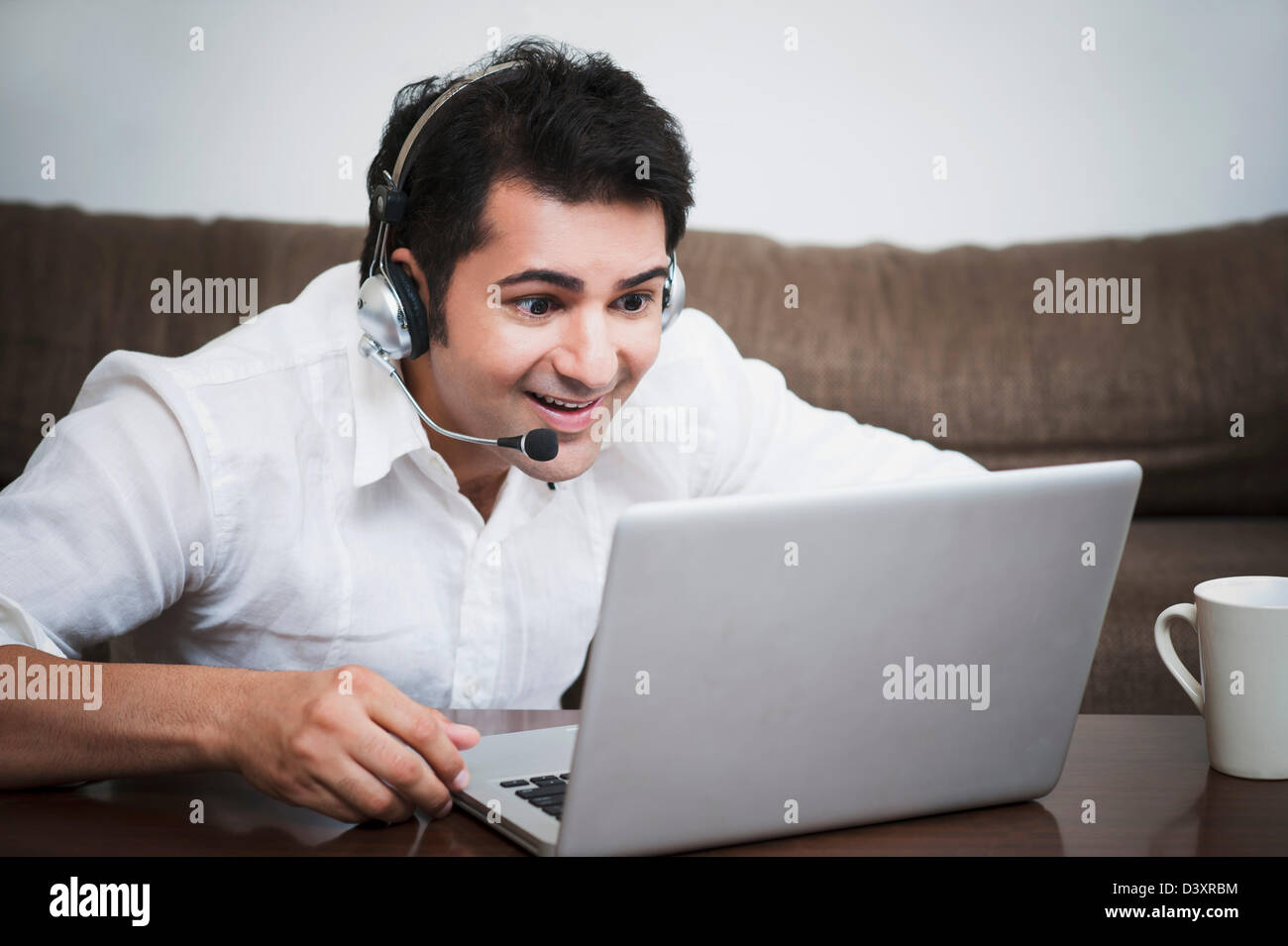 Customer service representative working on a laptop Stock Photo - Alamy