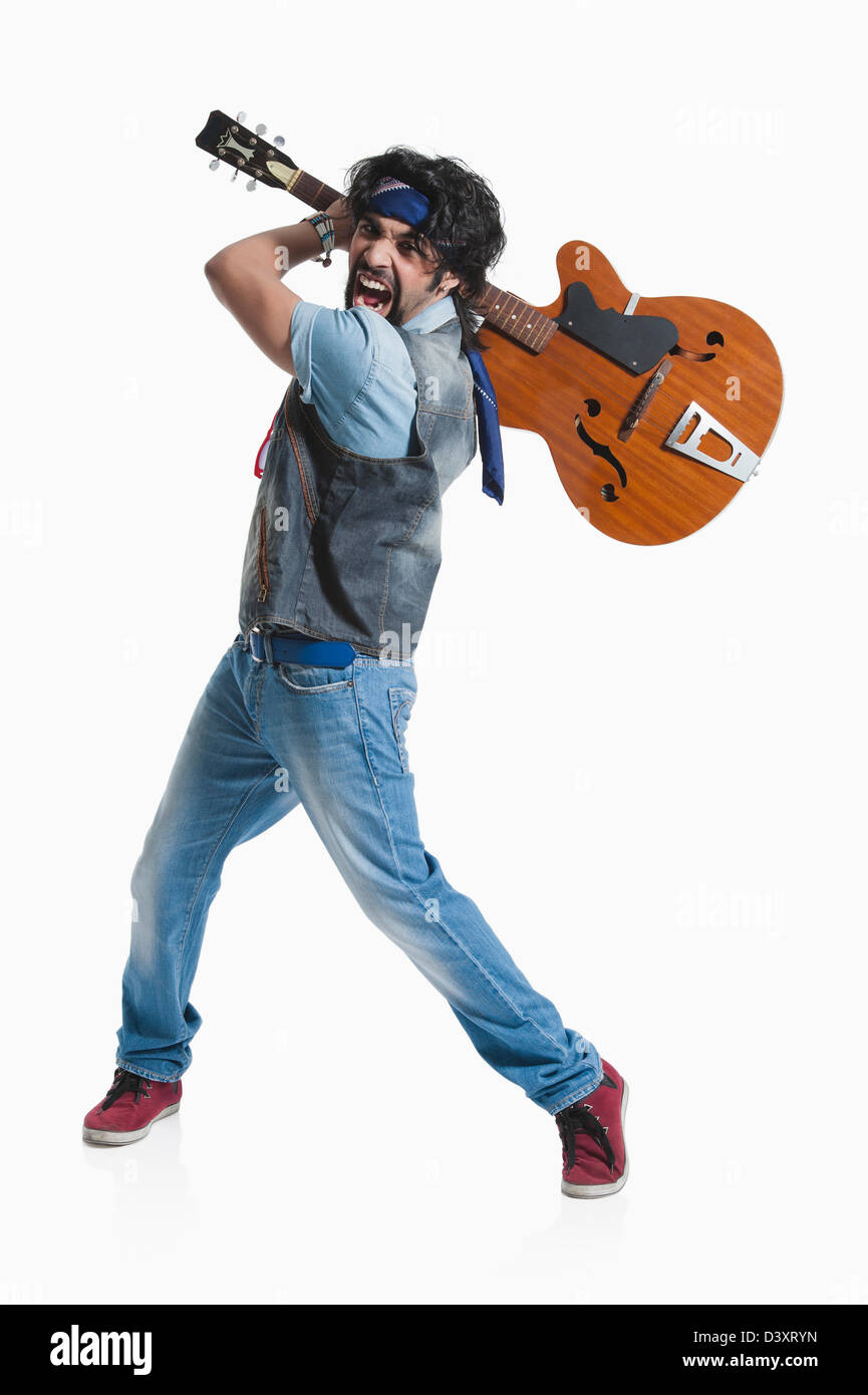 Musician breaking a guitar Stock Photo - Alamy